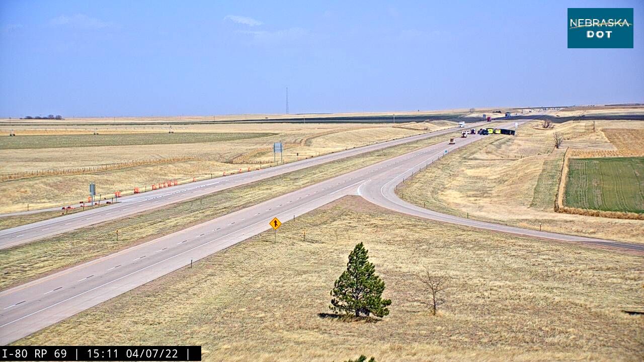 An overturned semi-tractor-trailer blocks eastbound lanes of I-80 at ...